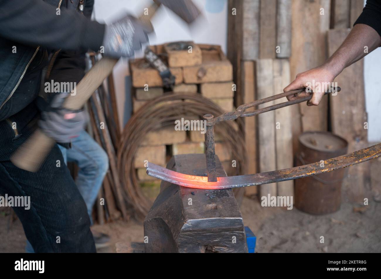 A forge where a hot iron rod is struck Stock Photo - Alamy