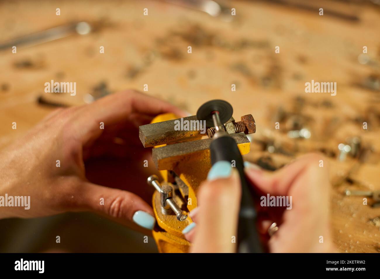 Woman using power working grinder machine, female hand grinds a metal ...