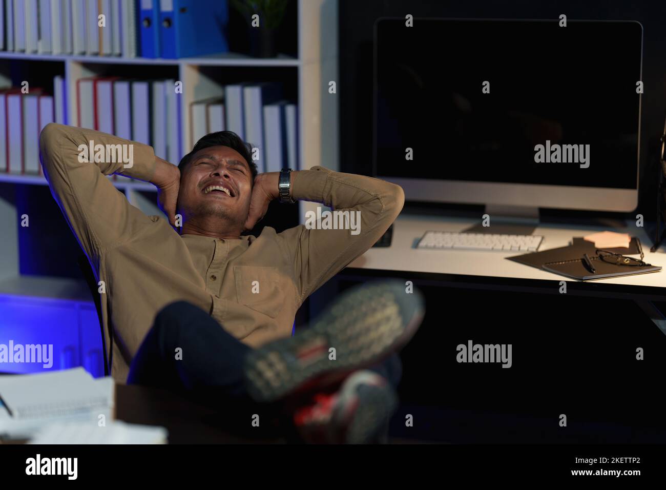 Stressed business man working over time at night. business account and ...