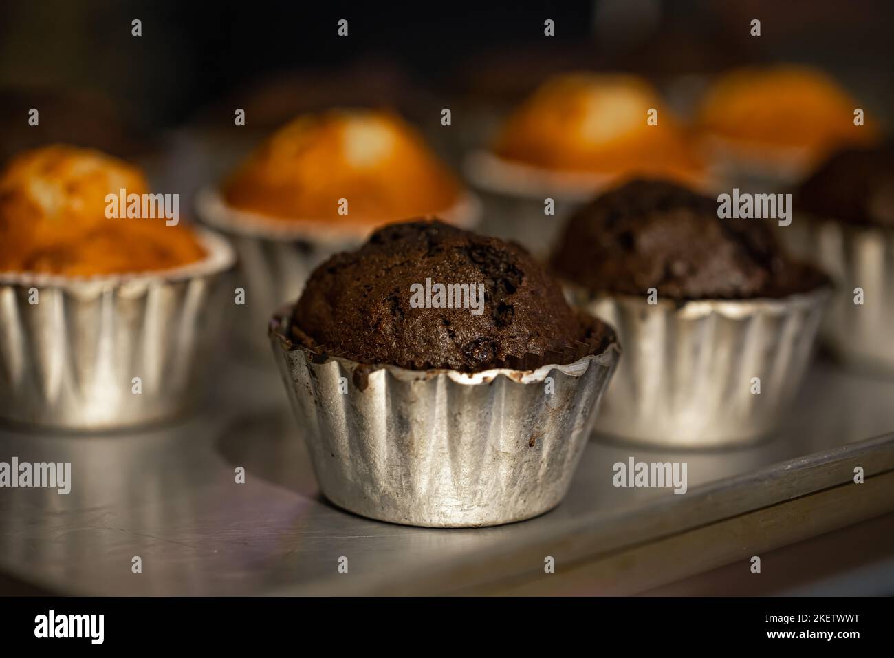 Freshly baked muffins in metal molds close-ups in a bakery Stock Photo ...