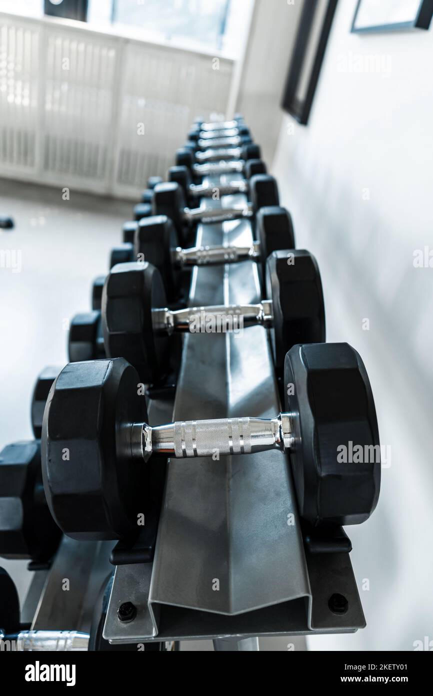 Rack with dumbbells of different weights Stock Photo - Alamy