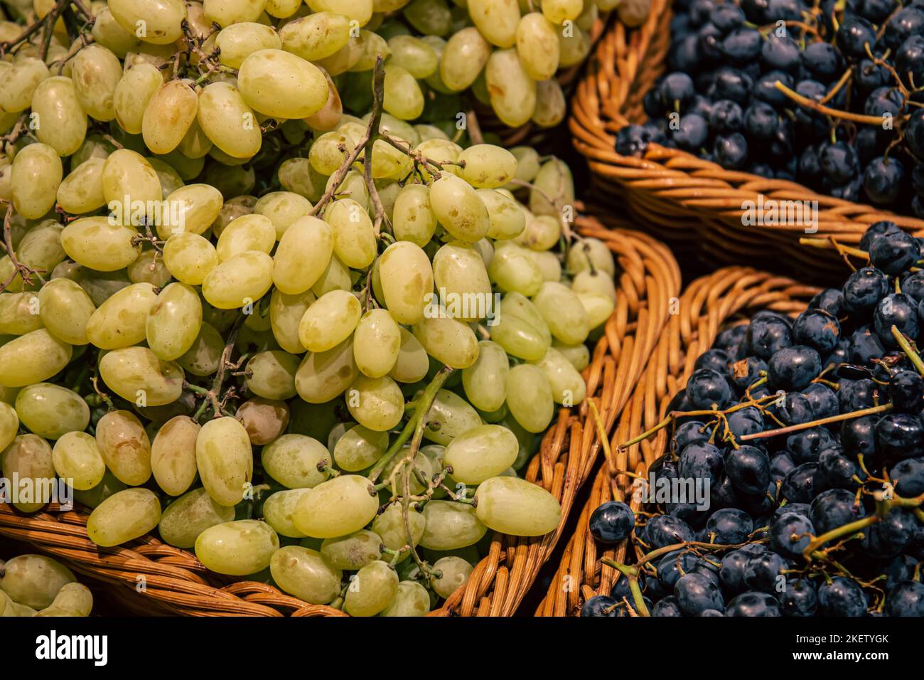 Baskets with different types of grapes on a supermarket showcase Stock ...