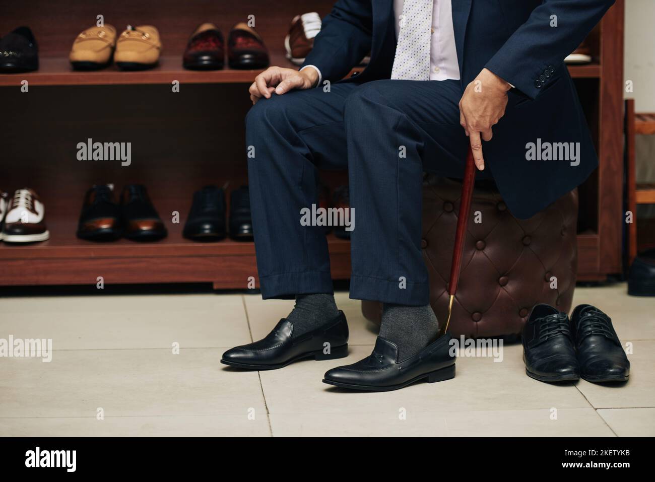 Cropped image of man trying on shoes in store Stock Photo - Alamy