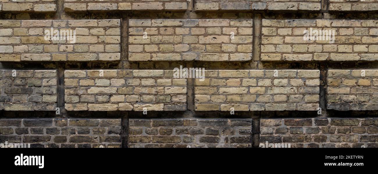 Wide weathered beige brown brick wall background Stock Photo - Alamy