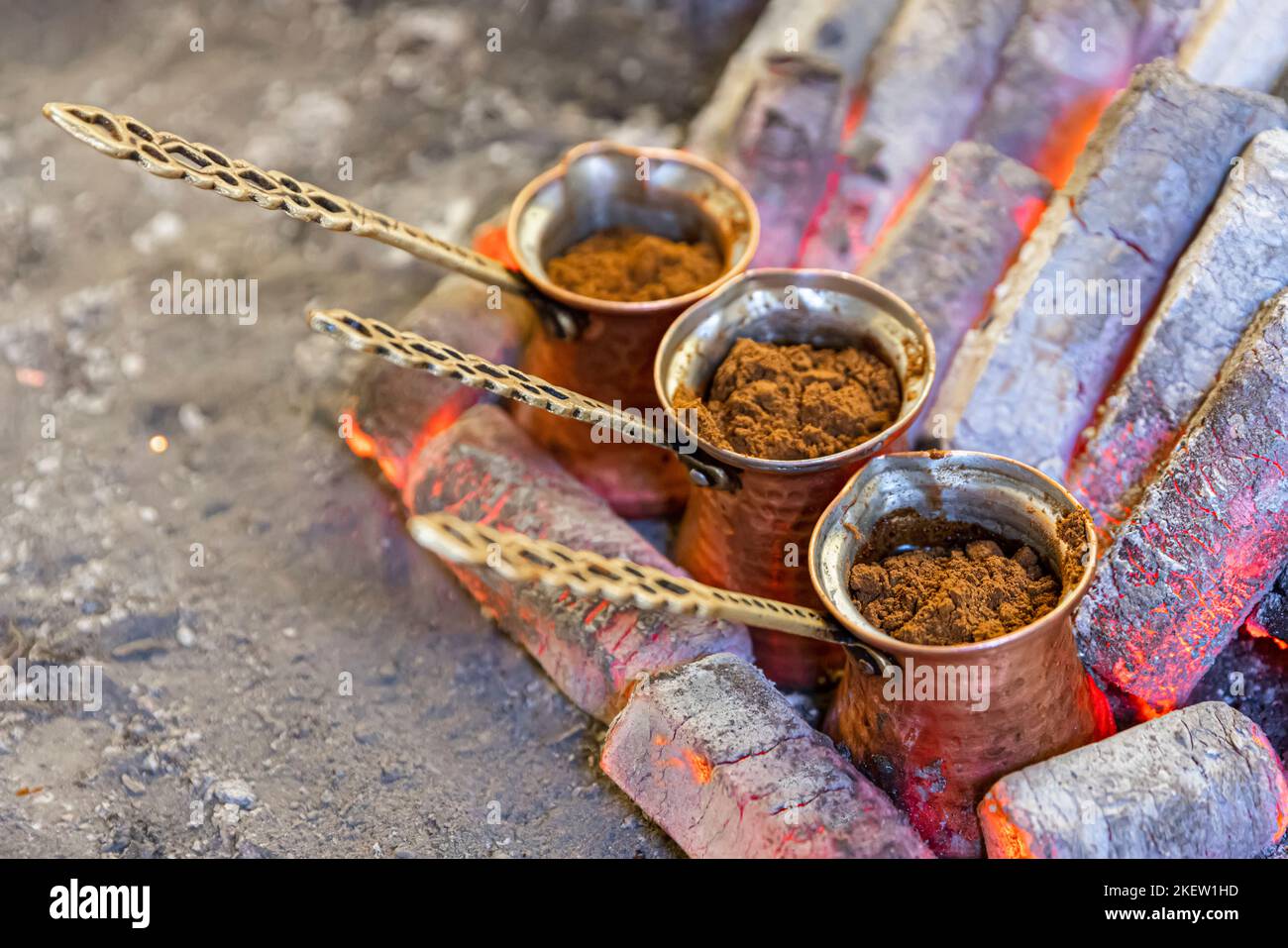 Turkish coffee cooked on embers. Street vendor cooks Turkish coffee on ...