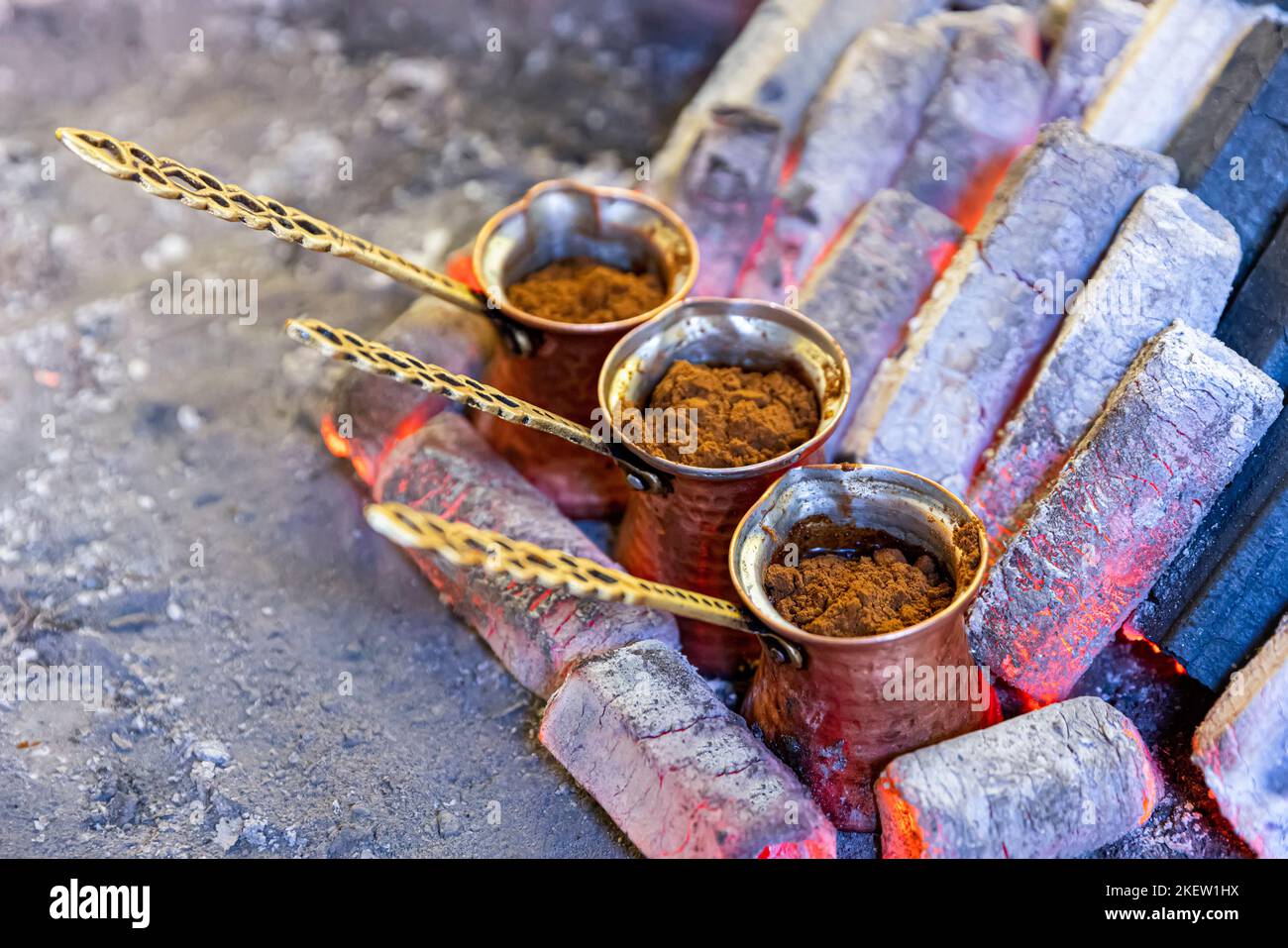 Turkish coffee cooked on embers. Street vendor cooks Turkish coffee on ...