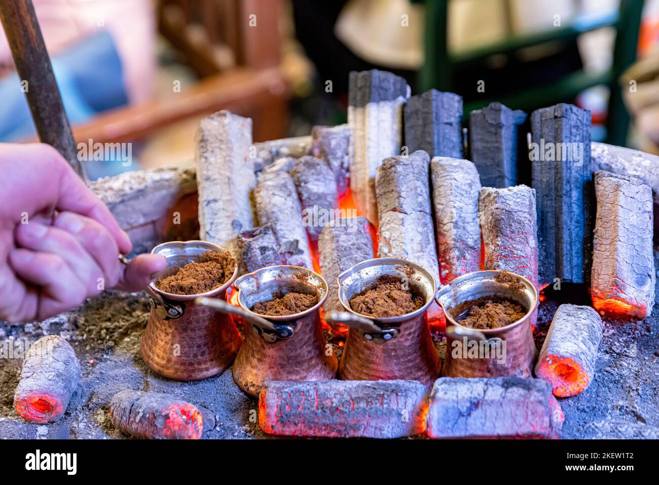 Turkish coffee cooked on embers. Street vendor cooks Turkish coffee on ...