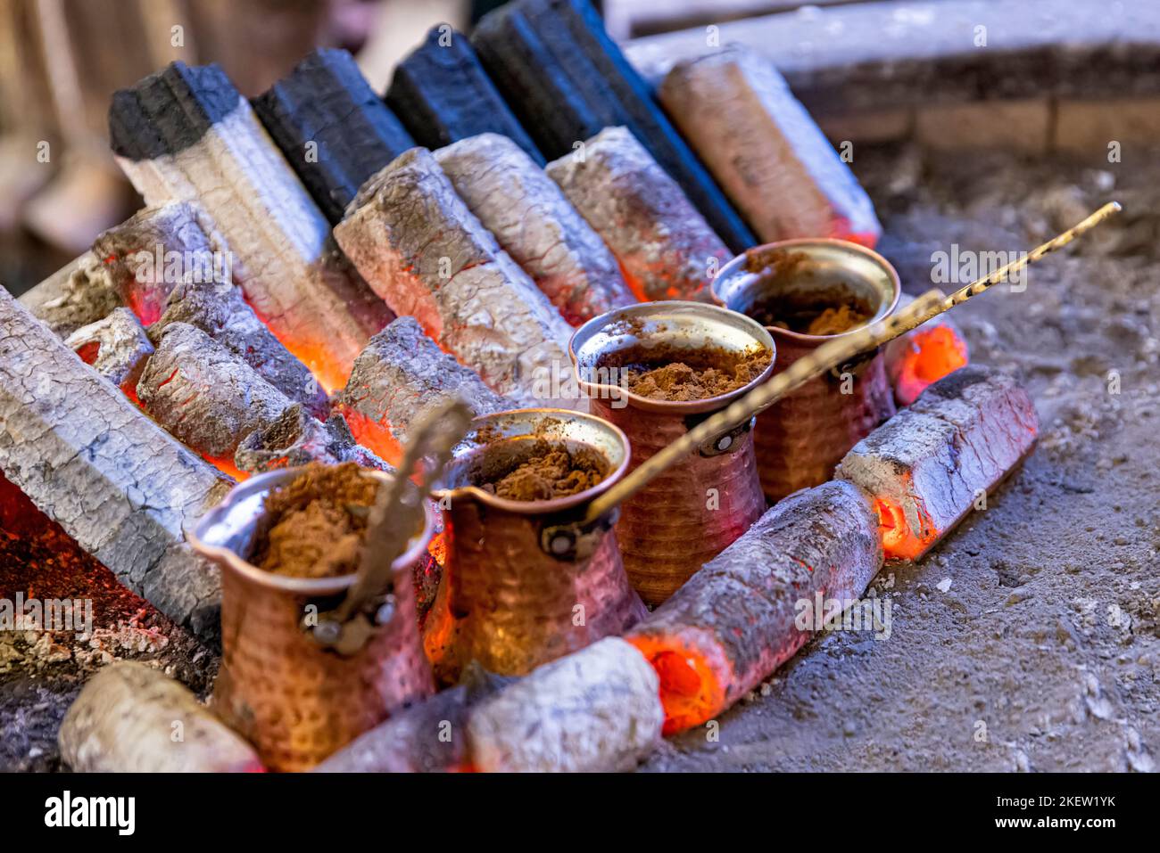 Turkish coffee cooked on embers. Street vendor cooks Turkish coffee on ...