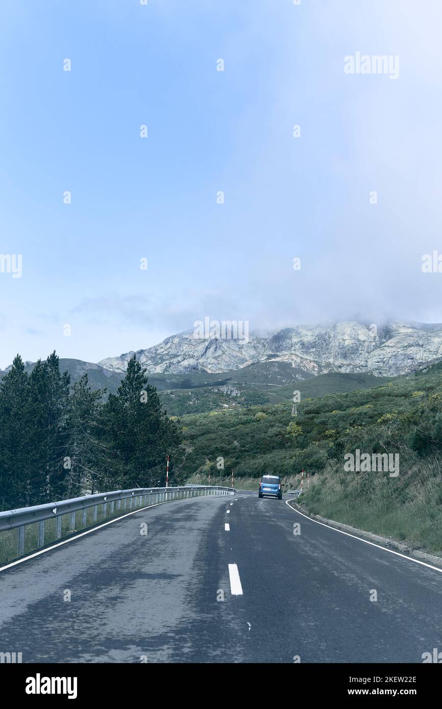 blue van driving along the lonely road that leads to the impressive ...