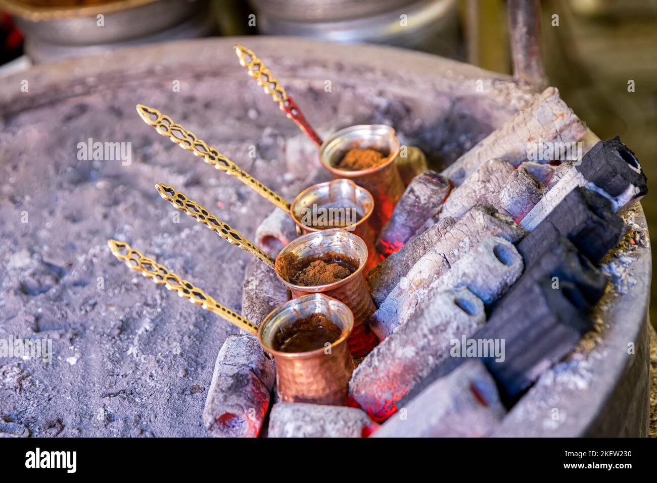 Turkish coffee cooked on embers. Street vendor cooks Turkish coffee on ...