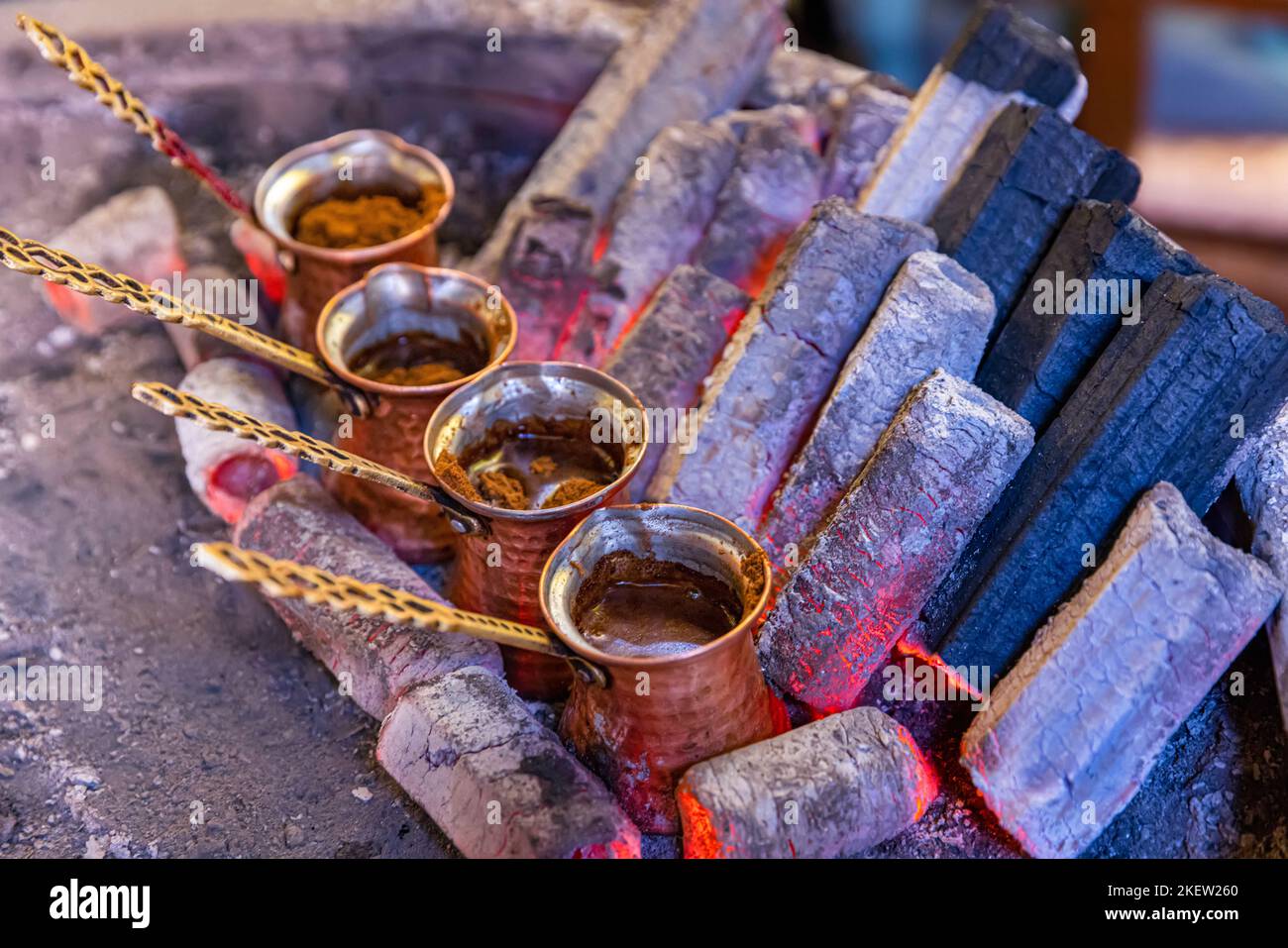 Turkish coffee cooked on embers. Street vendor cooks Turkish coffee on ...