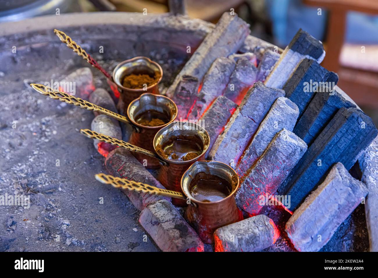 Turkish coffee cooked on embers. Street vendor cooks Turkish coffee on ...