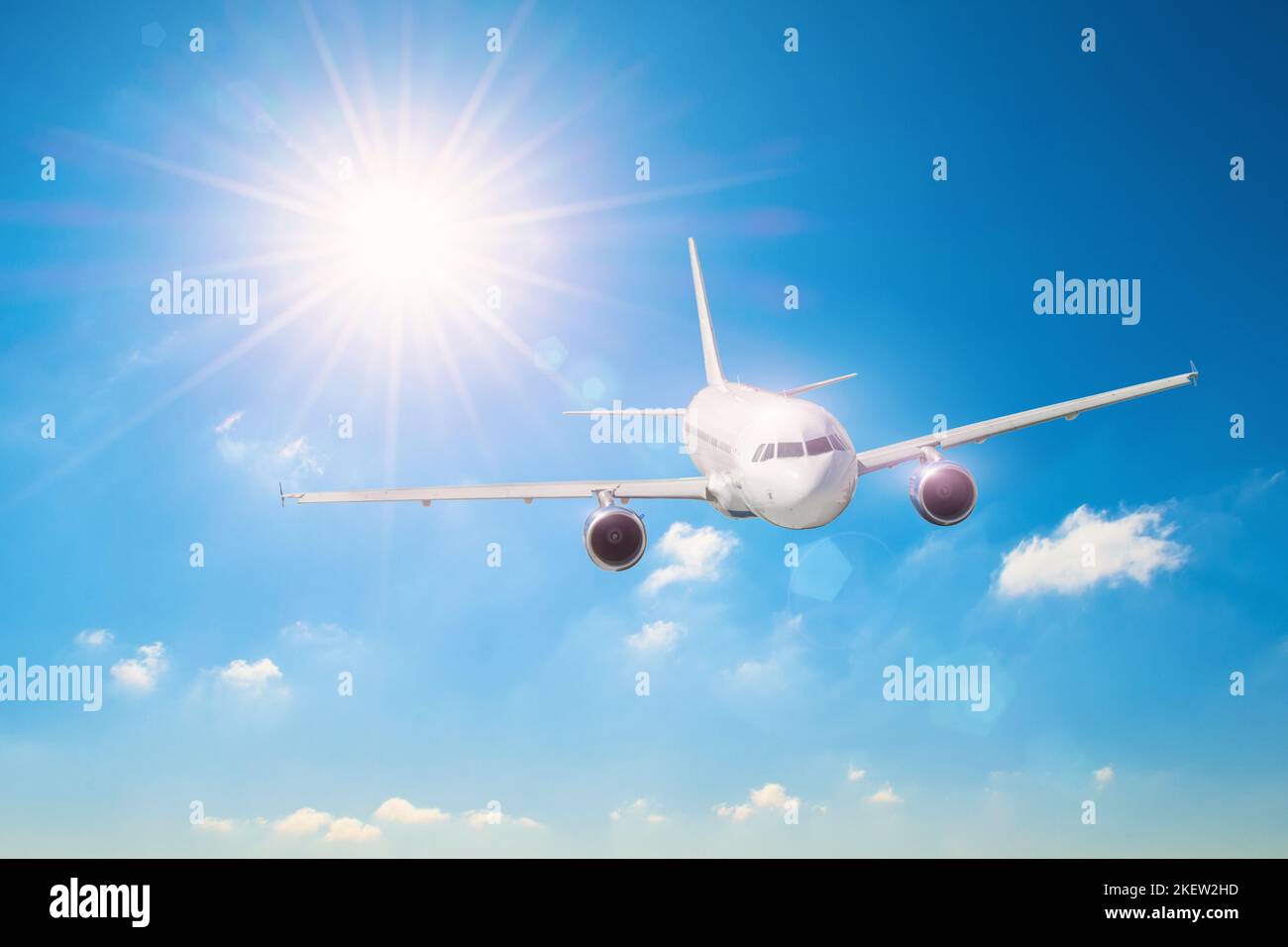 Sun with bright rays in the blue sky with white light clouds, flying ...