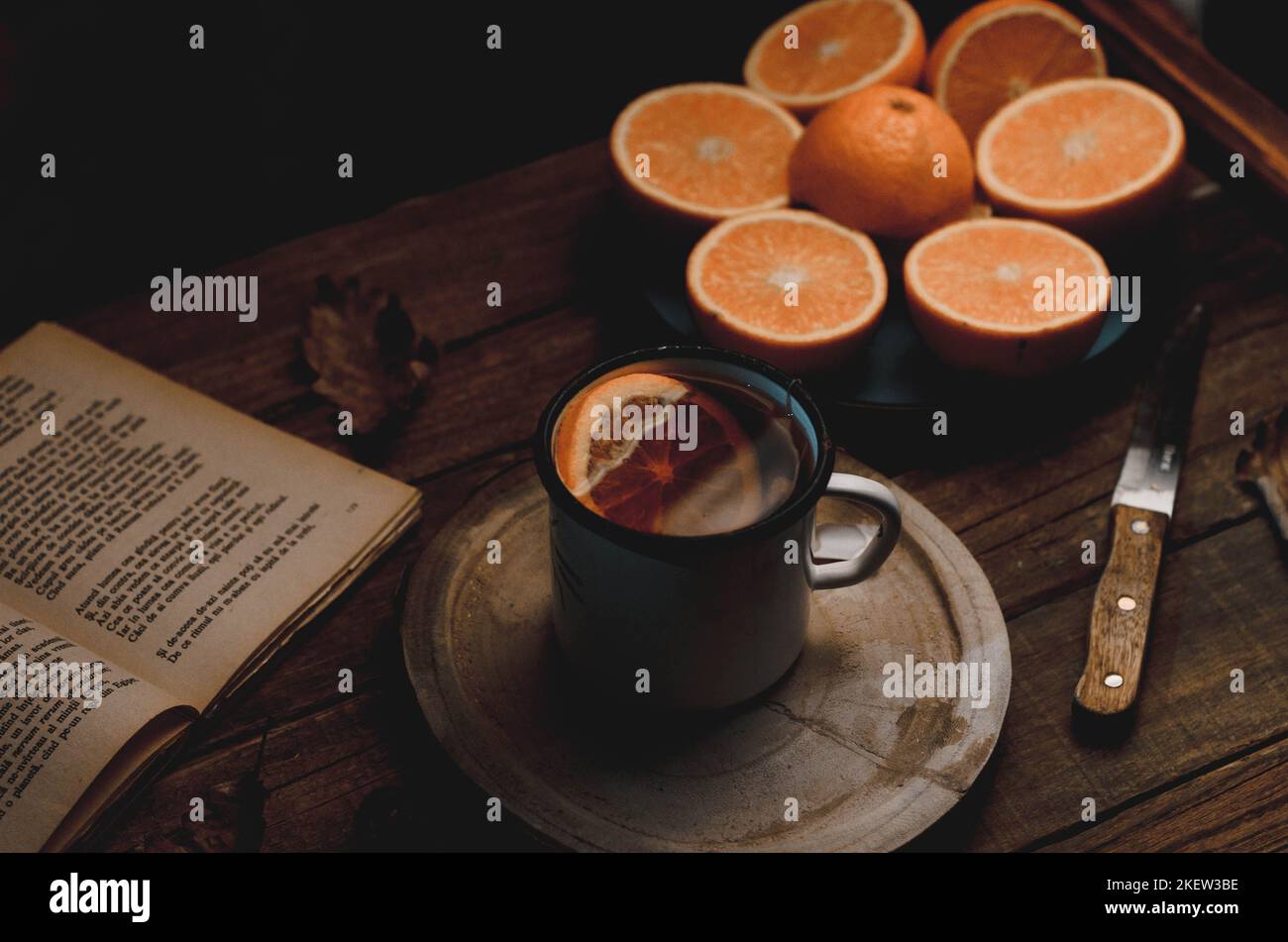 Cup of autumn tea with a book and yellow dry leaves near a window, copy ...