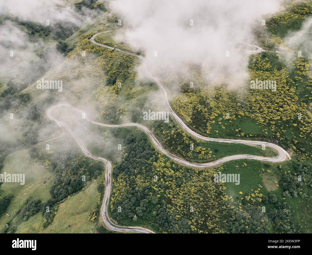 image taken with a drone of a long road with many curves on the slope ...