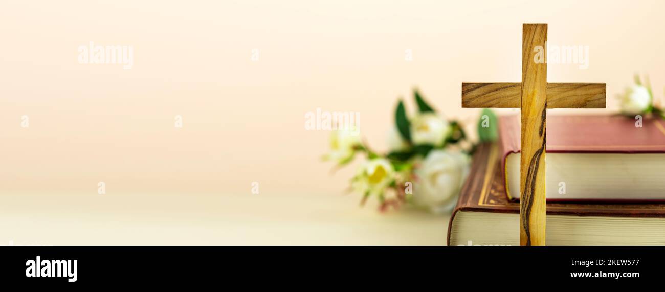 Religion banner with wooden cross with closed red Christian bibles with ...