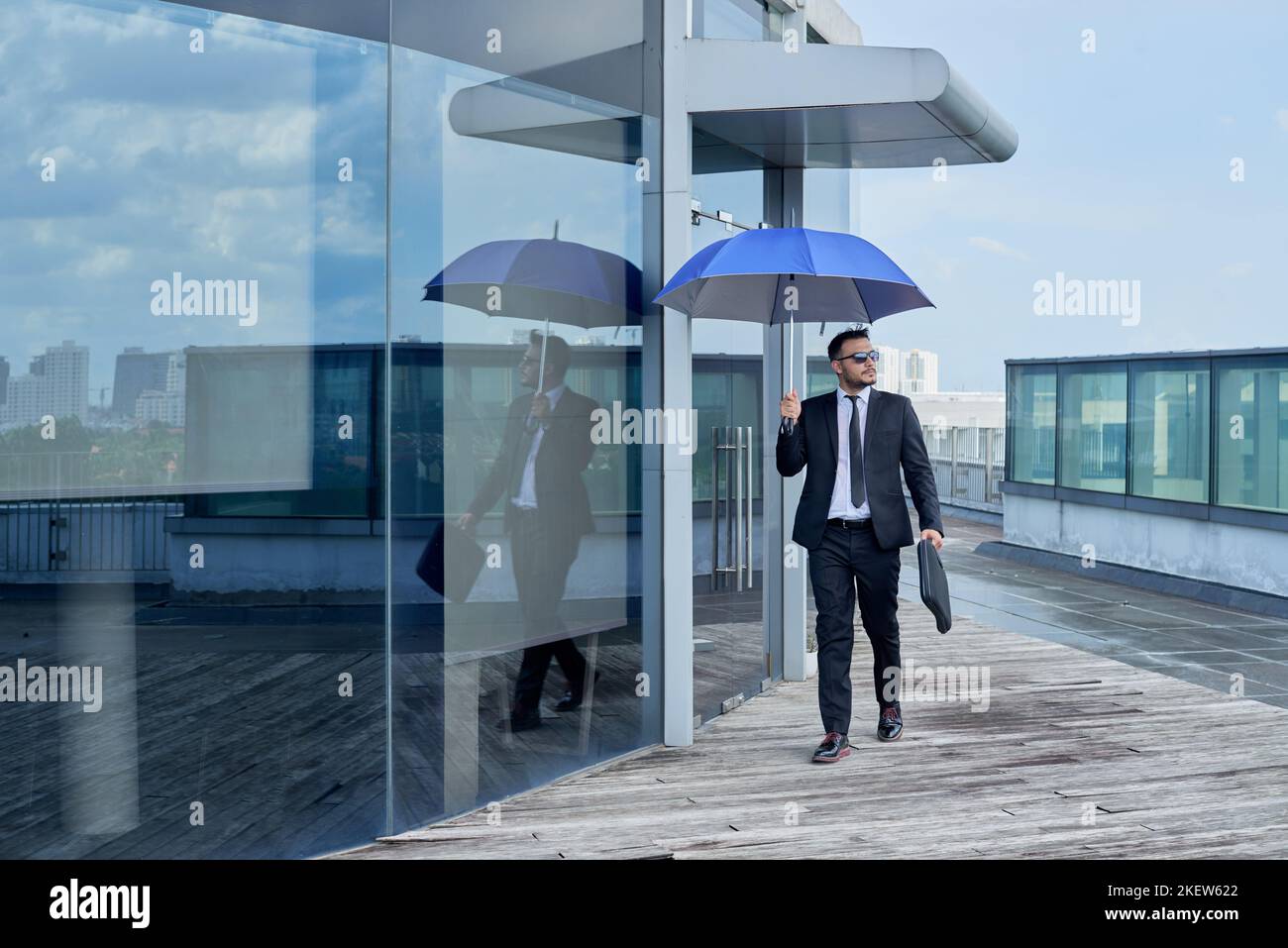 Elegant entrepreneur walking to office on rainy day Stock Photo - Alamy