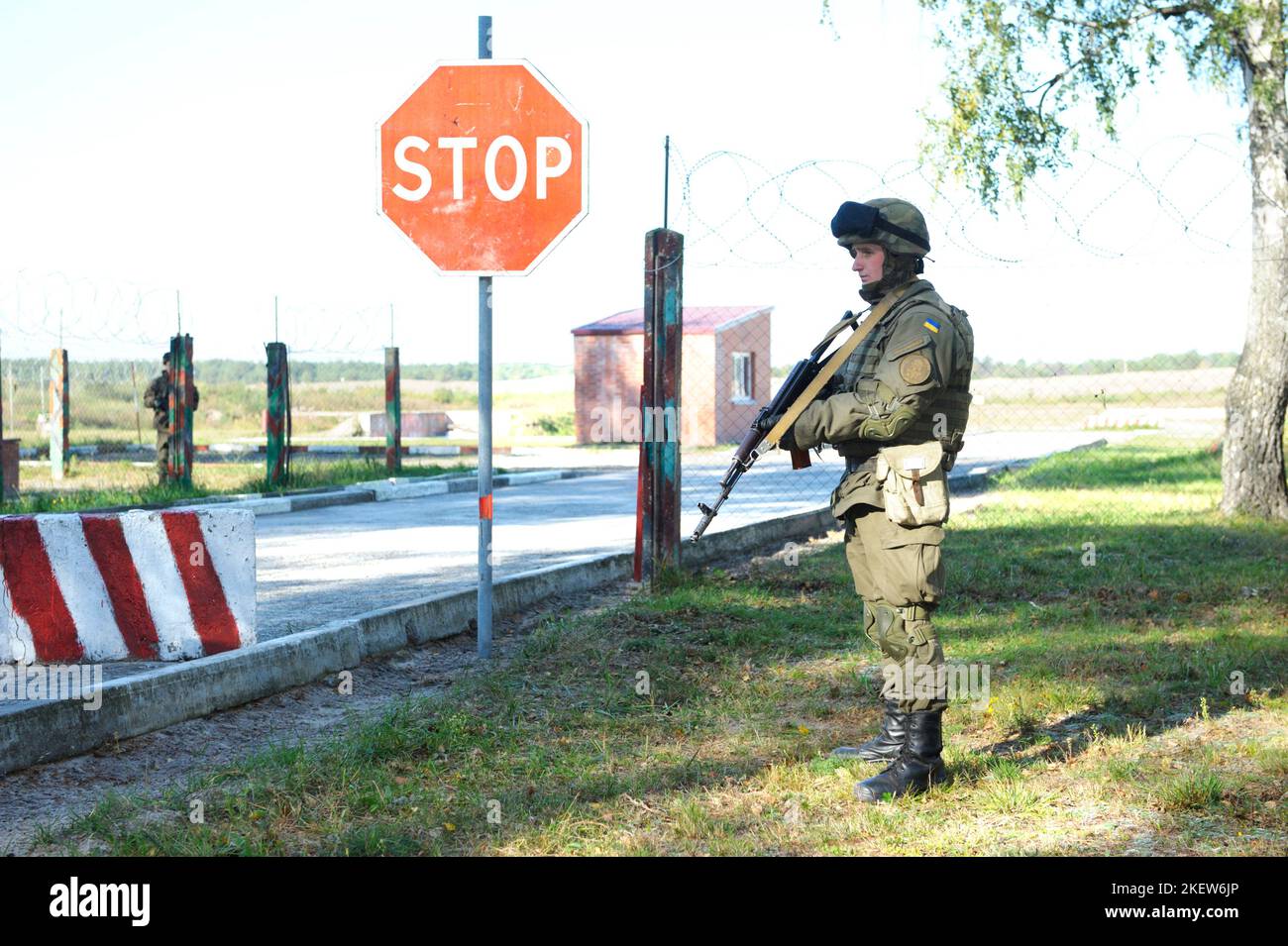 Fully equipped soldiers guarding the checkpoint in front of the sign ...