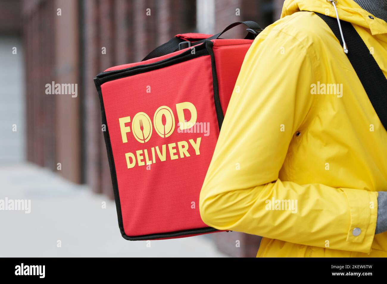 Close-up of young courier with big red backpack containing orders of ...