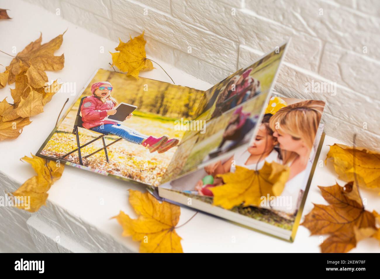 dry autumn leaves and a photo album Stock Photo - Alamy