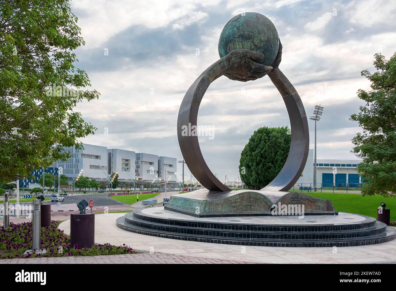 Hands rising from a book support the globe in this sculpture at Qatar's ...