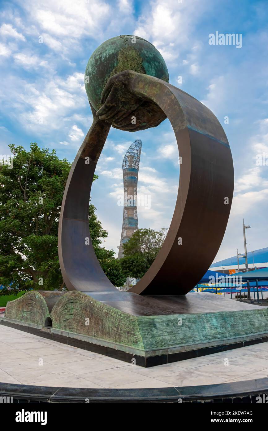Hands rising from a book support the globe in this sculpture at Qatar's ...