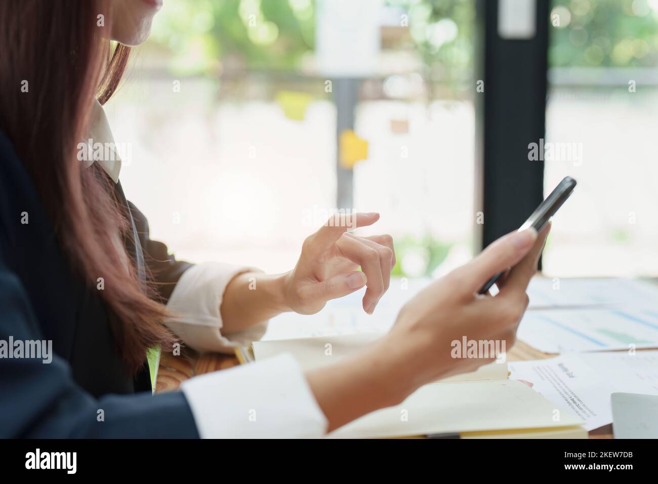 Asian businesswoman using the phone to contact a business partner Stock ...