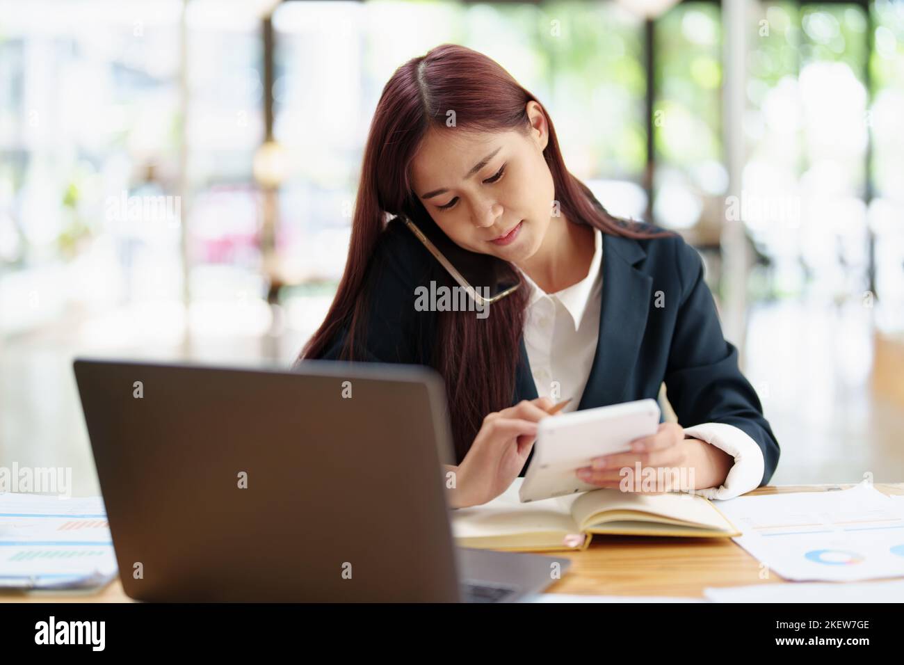 Asian businesswoman using the phone to contact a business partner Stock ...