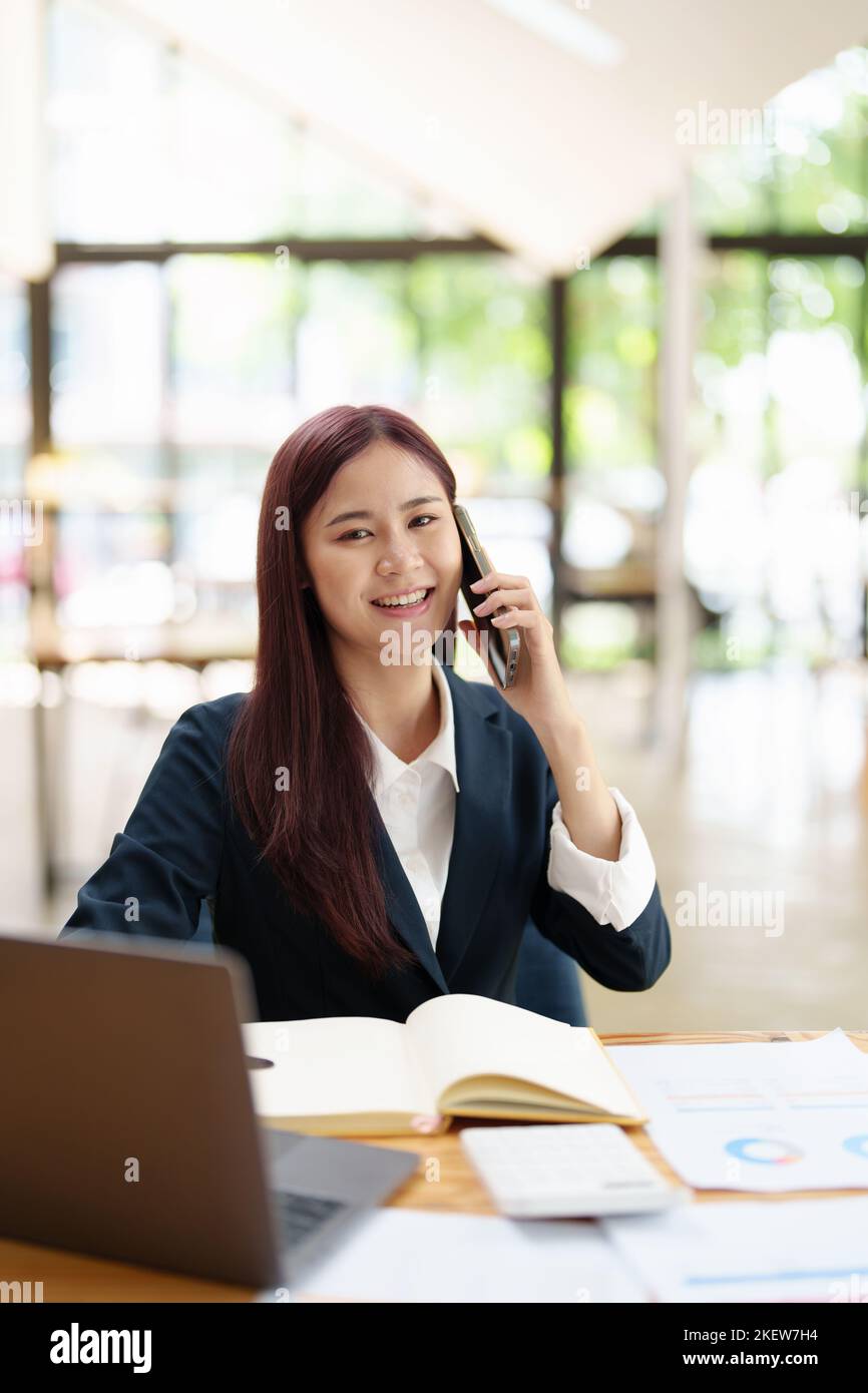 Asian businesswoman using the phone to contact a business partner Stock ...