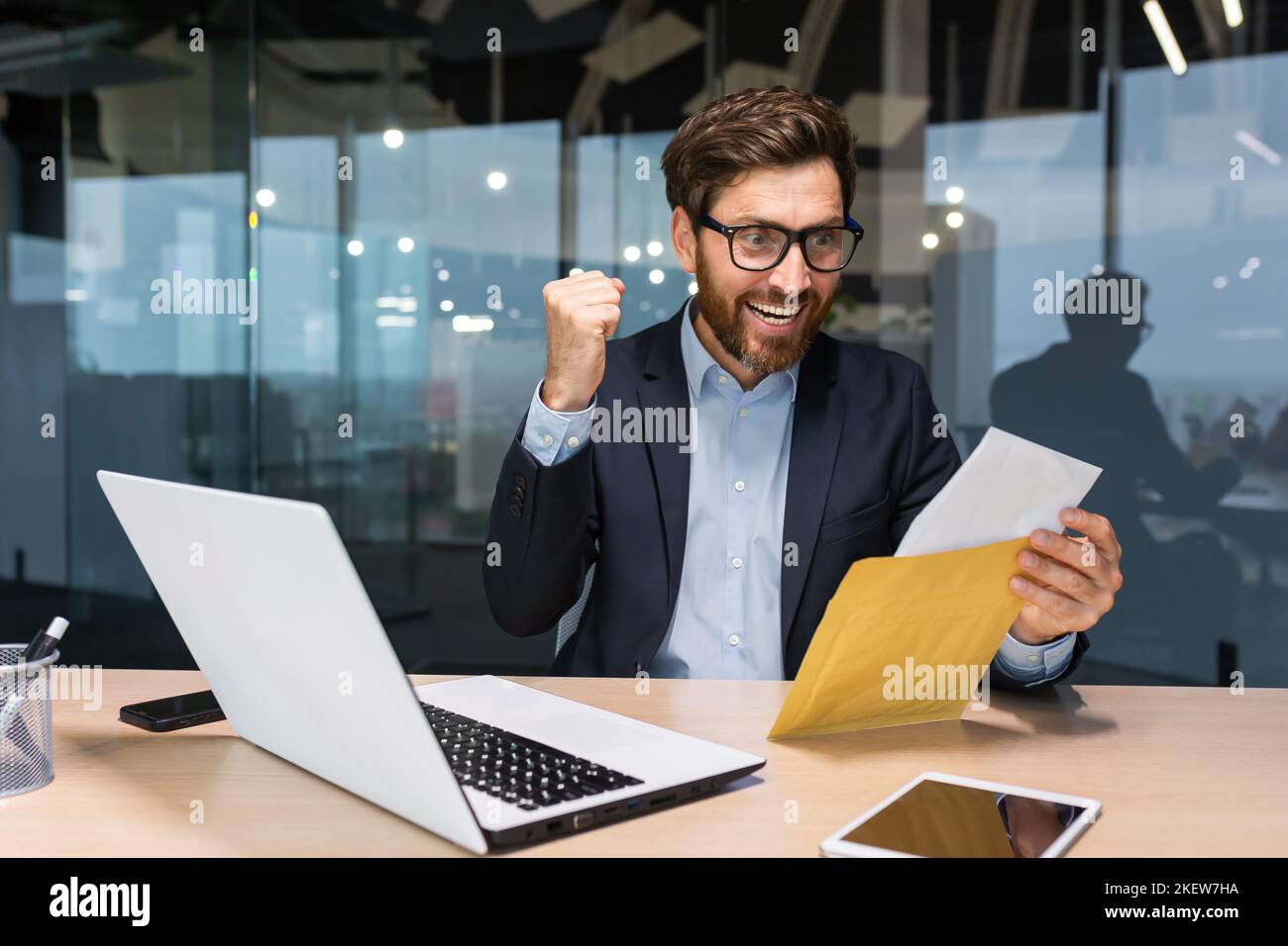 Mature businessman happy with good news received letter in envelope ...
