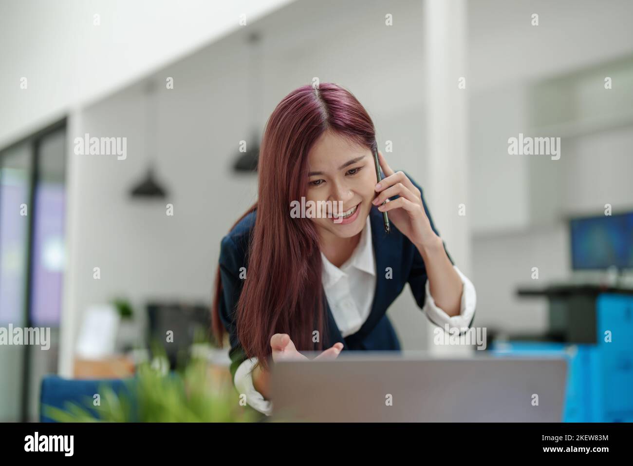 Asian businesswoman using the phone to contact a business partner Stock ...