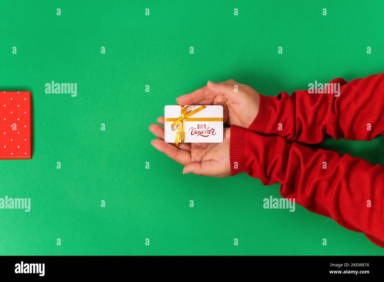 Gift voucher or bonus card template with ribbon in female hands, green ...