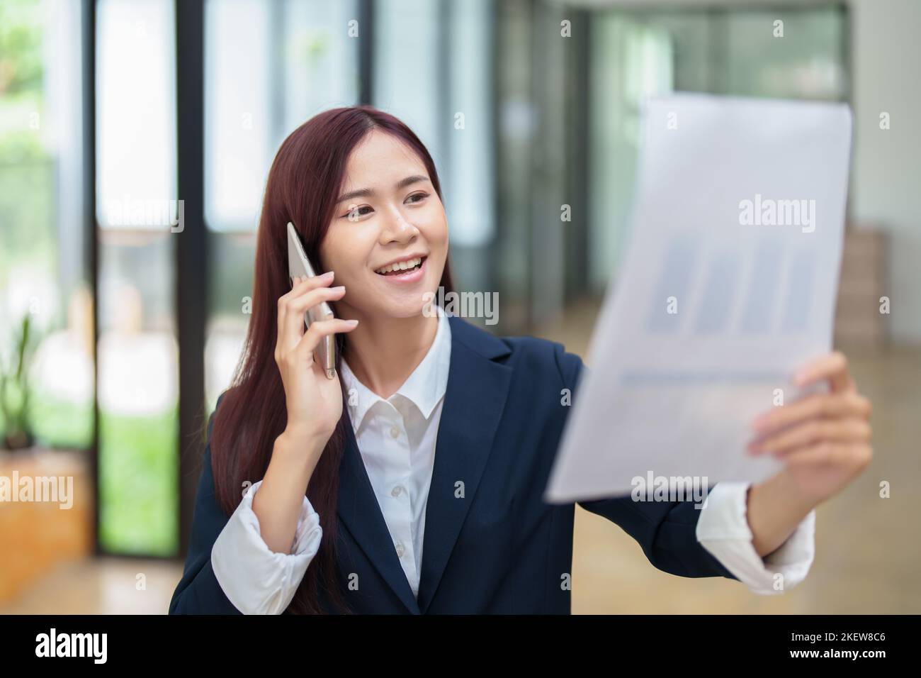 Asian businesswoman using the phone to contact a business partner Stock ...