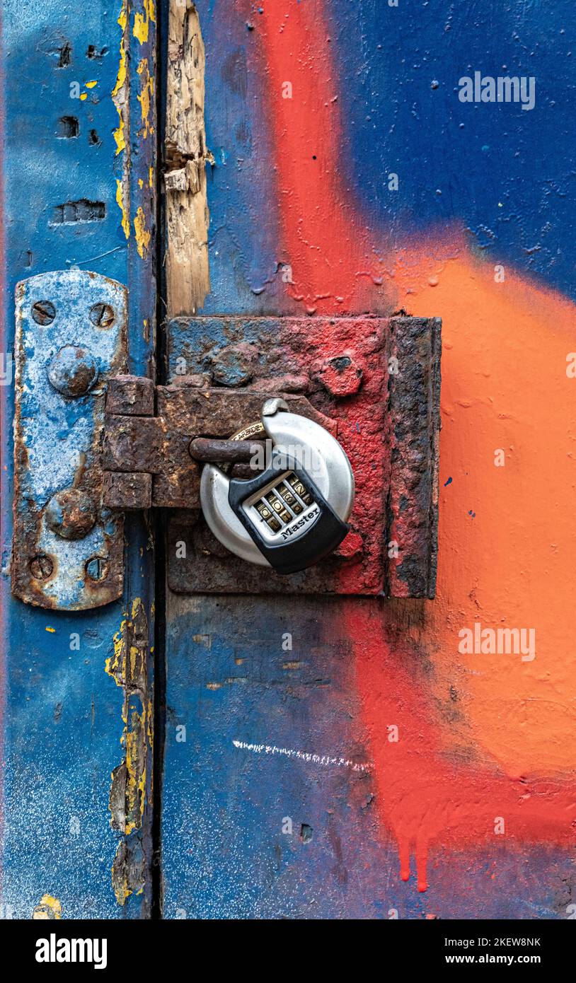 Bright colour door with closed padlock Stock Photo - Alamy