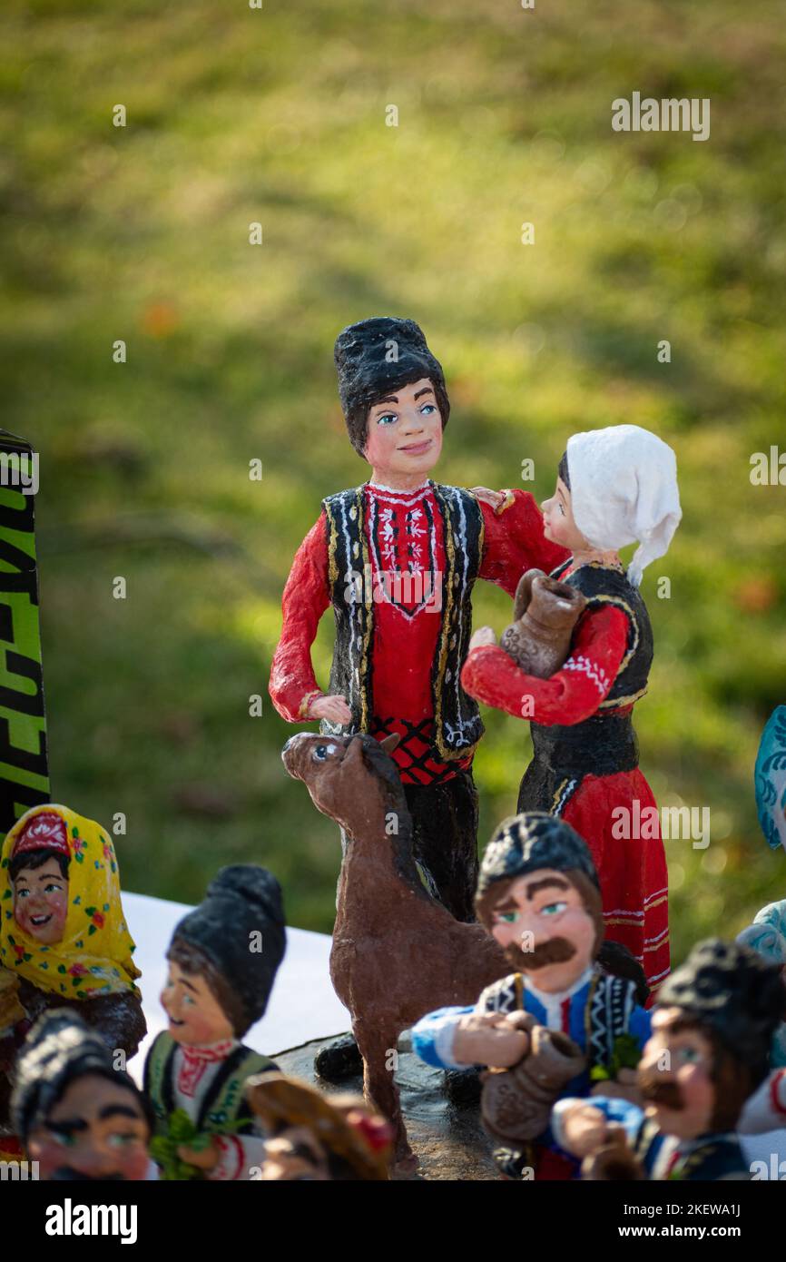 Assortment of clay souvenirs. Souvenir clay figurines of men and women ...