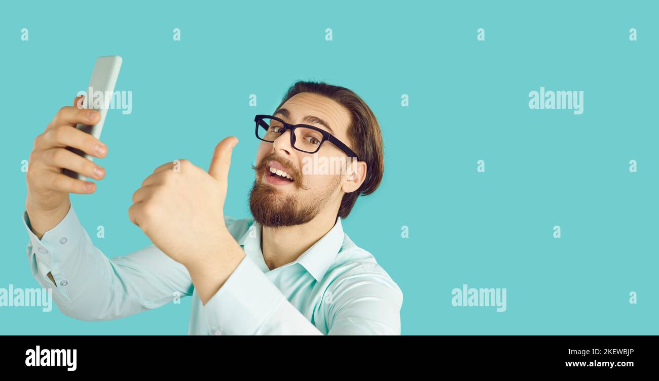 Happy man isolated on copy space banner background using cellphone and ...