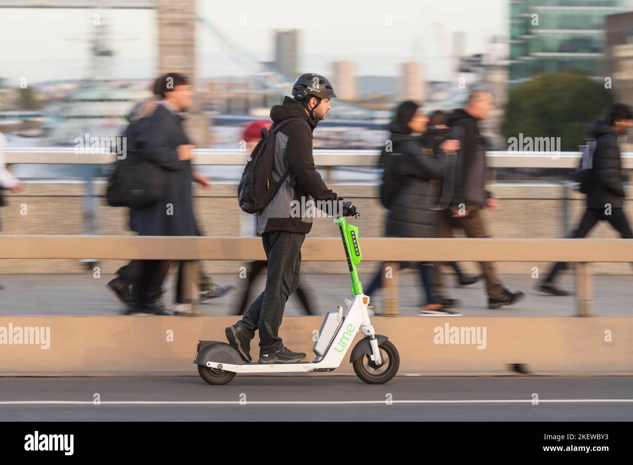 A man riding on a Lime e-scooter part of the Transport for London e-scooter hire scheme, across ...