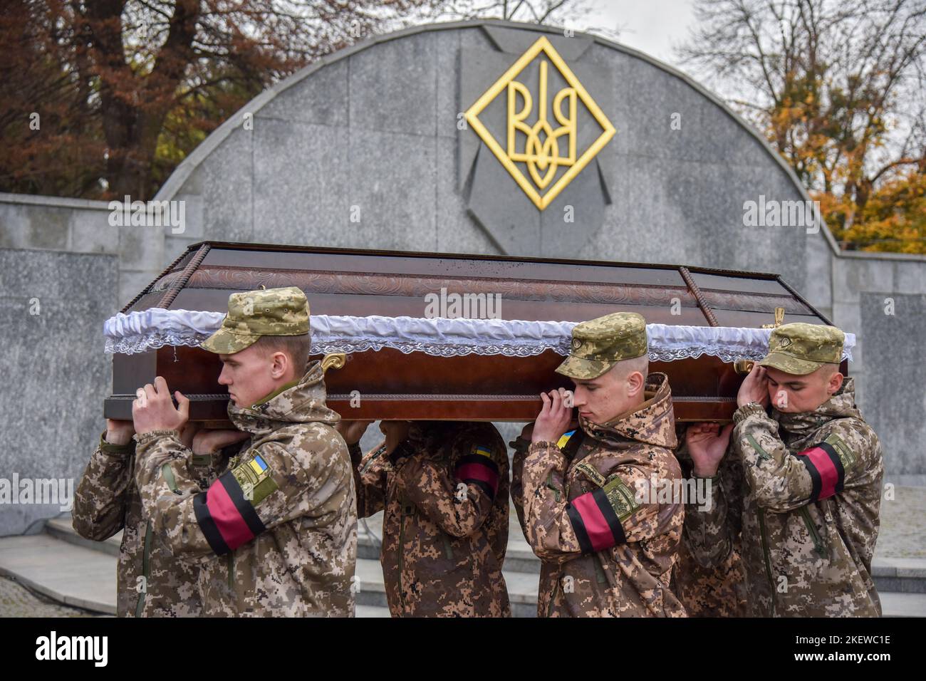 Soldiers carry a coffin with a body of a defender of Ukraine, who died ...