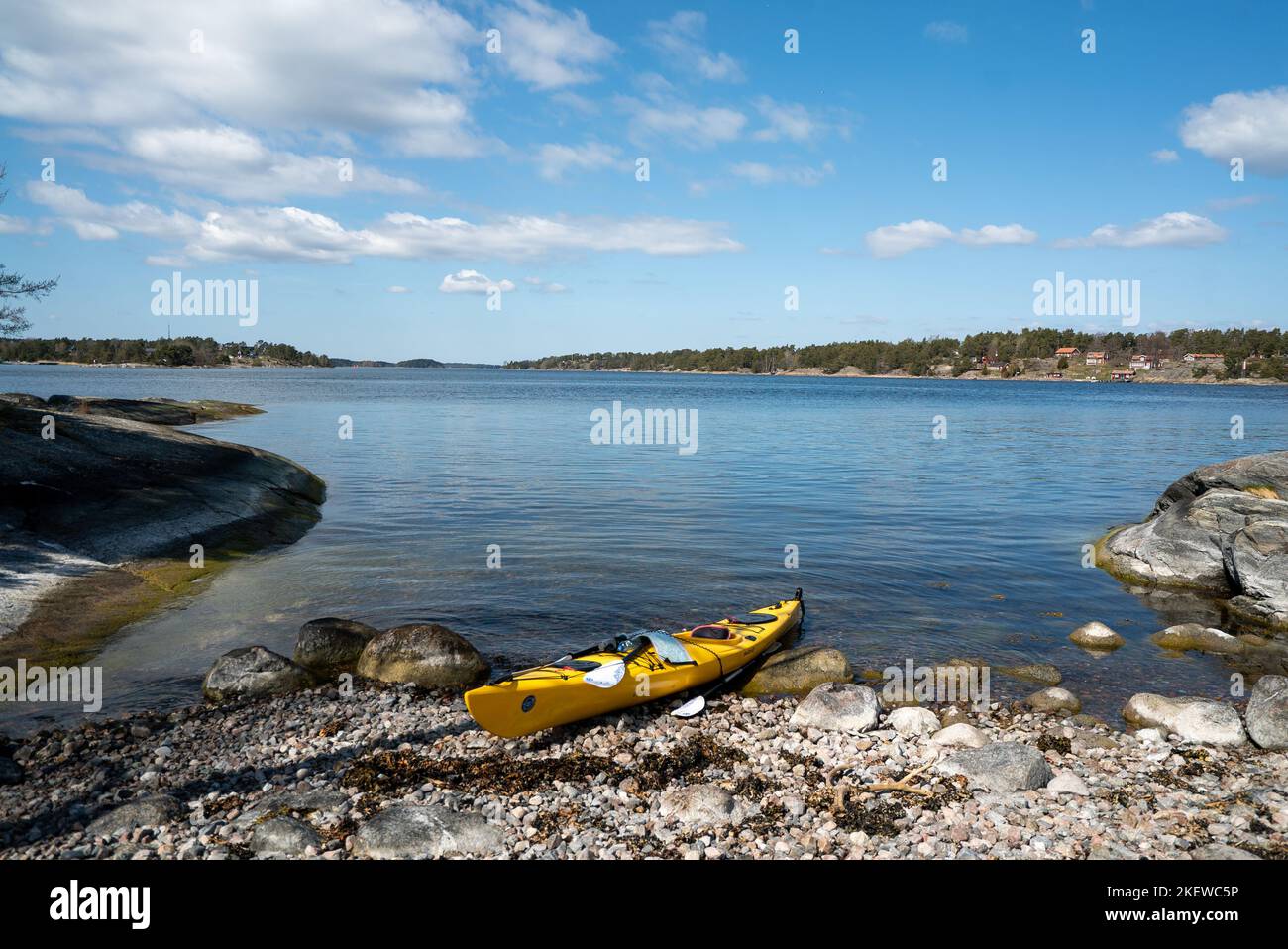 A single kayak beached / docked on the shore of an island in the ...