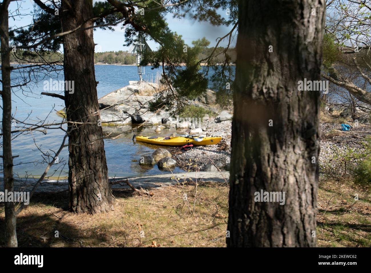 A single kayak beached / docked on the shore of an island in the ...