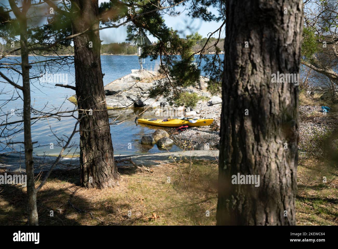 A single kayak beached / docked on the shore of an island in the ...