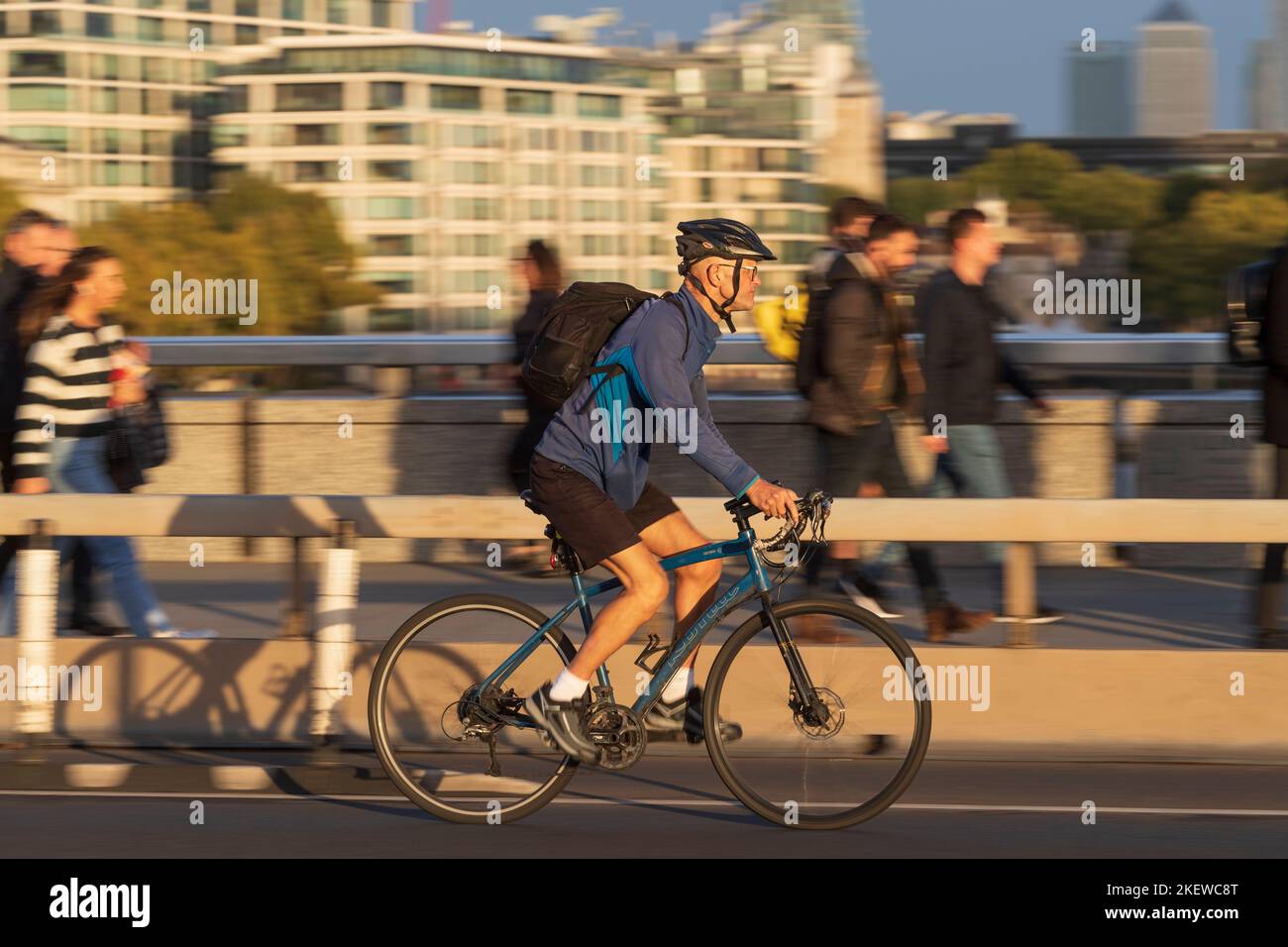 A man cycling during rush hour, across London Bridge, London, UK. 17 ...
