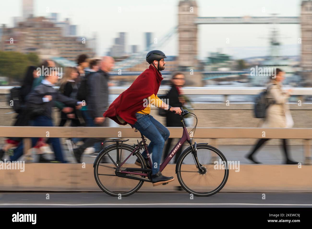 A man cycling during rush hour, across London Bridge, London, UK. 18 ...