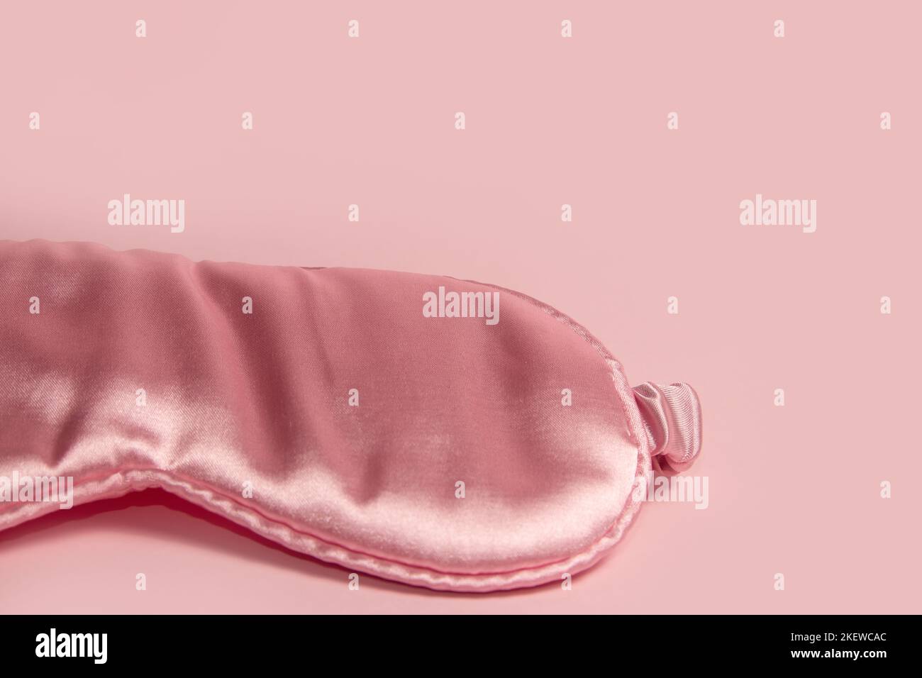 Pink silk sleeping mask on a pastel pink background Stock Photo - Alamy