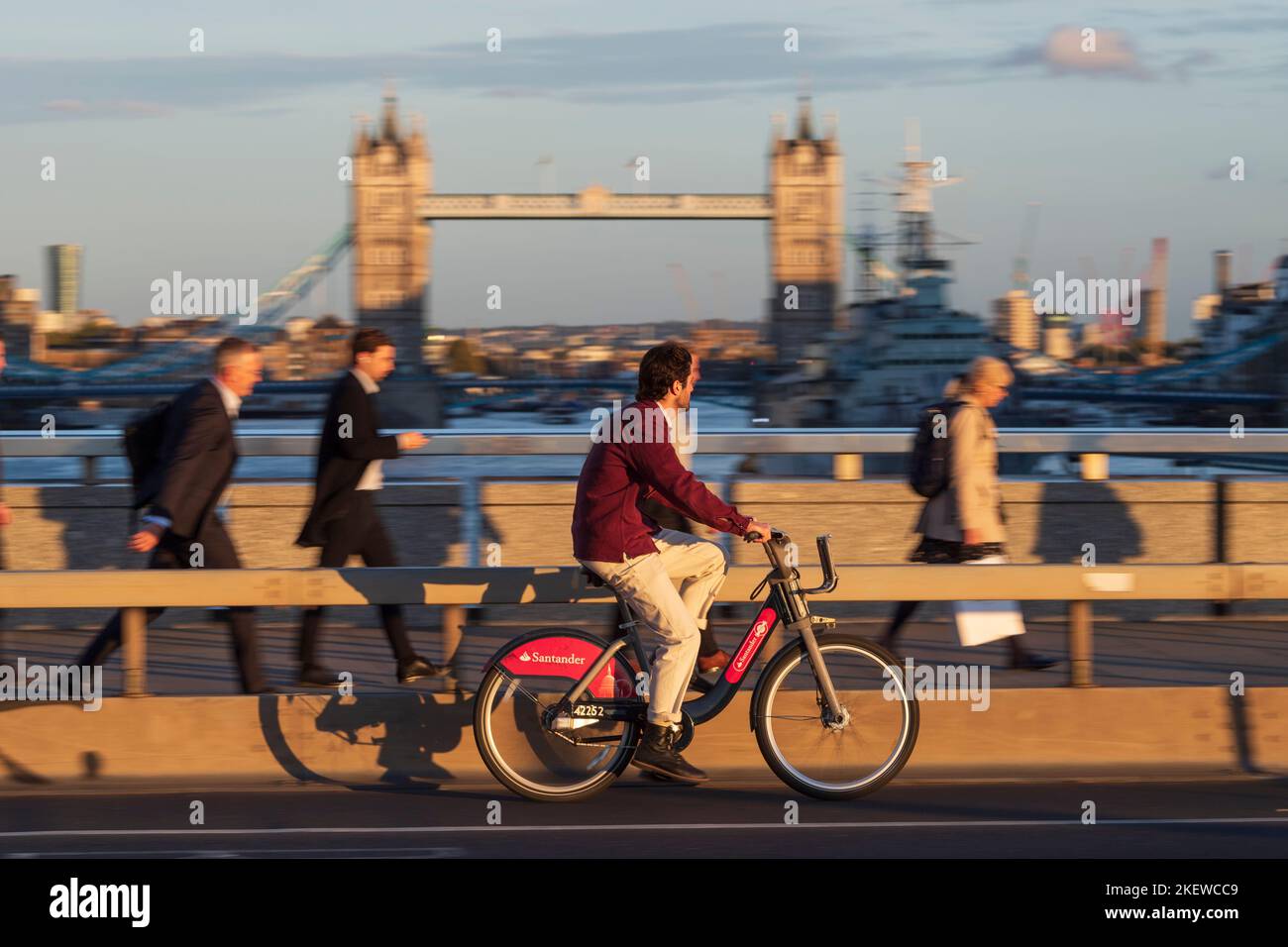 A man cycling across London Bridge during rush hour, on a Transport for ...