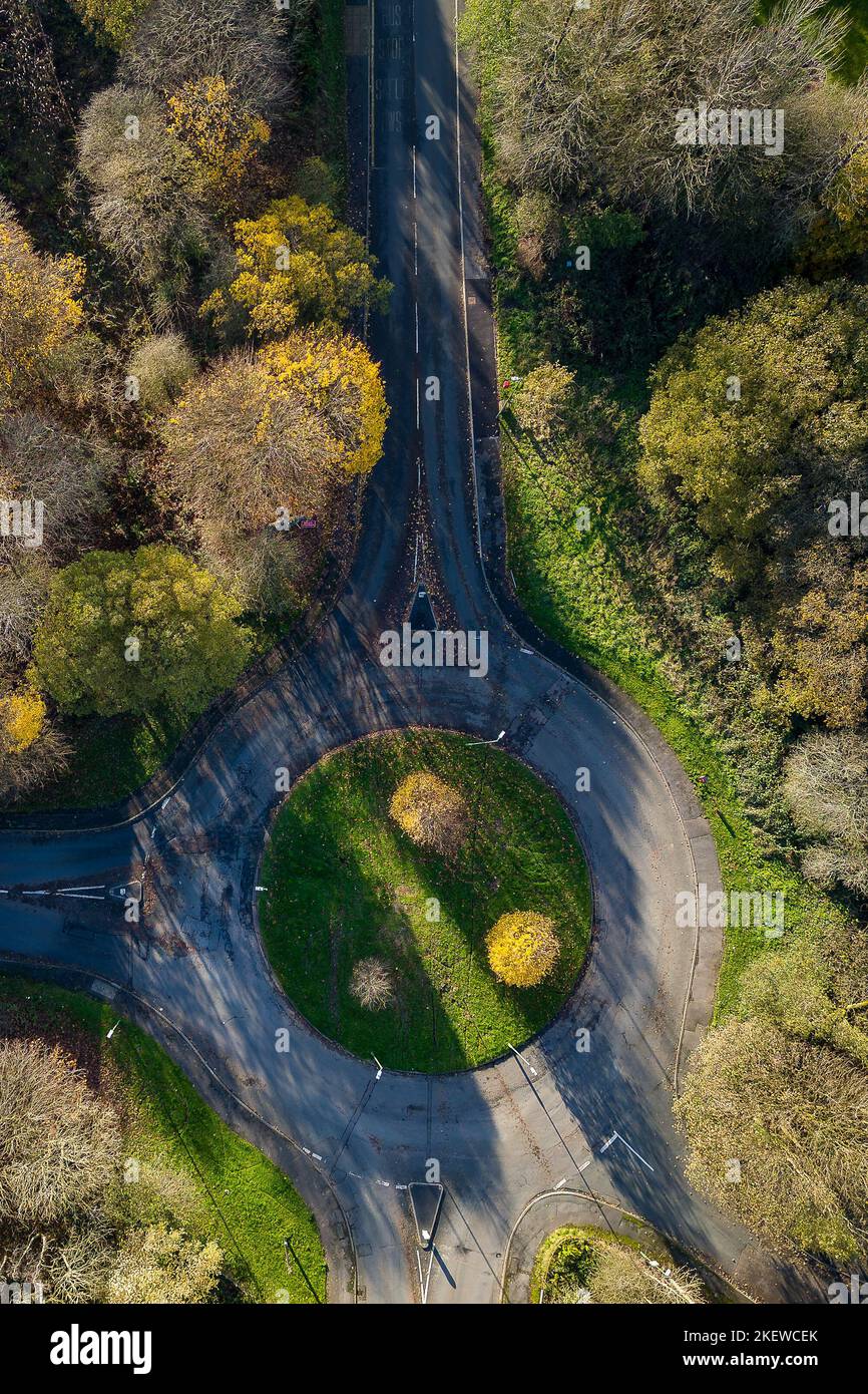 A small traffic roundabout surrounded by beautiful autumn coloured ...