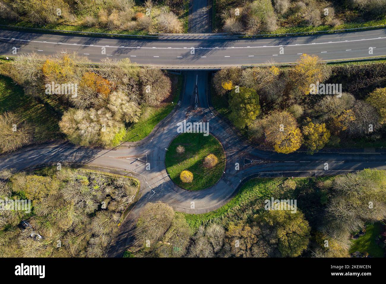 Aerial view of a small traffic roundabout on a rural road with fall ...
