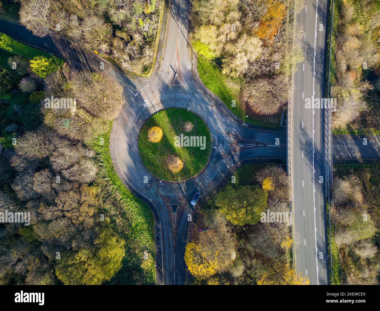 Aerial view of a traffic roundabout surrounded by autumn trees (Wales ...