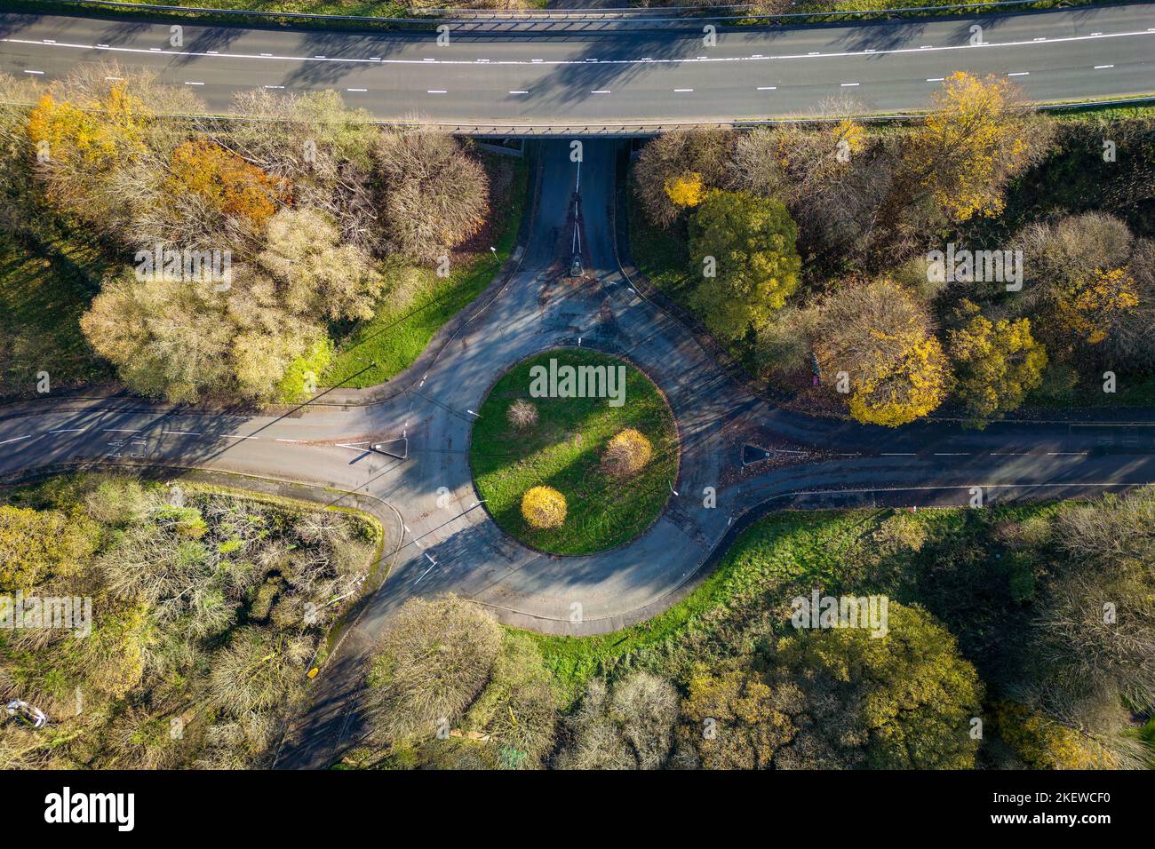 Aerial view of a small traffic roundabout on a rural road with fall ...