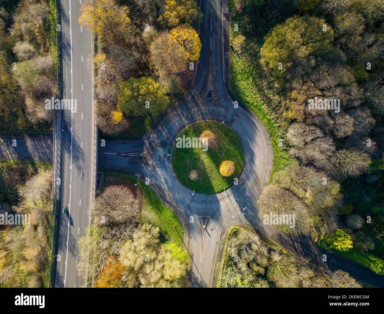 Aerial view of a traffic roundabout surrounded by autumn trees (Wales ...